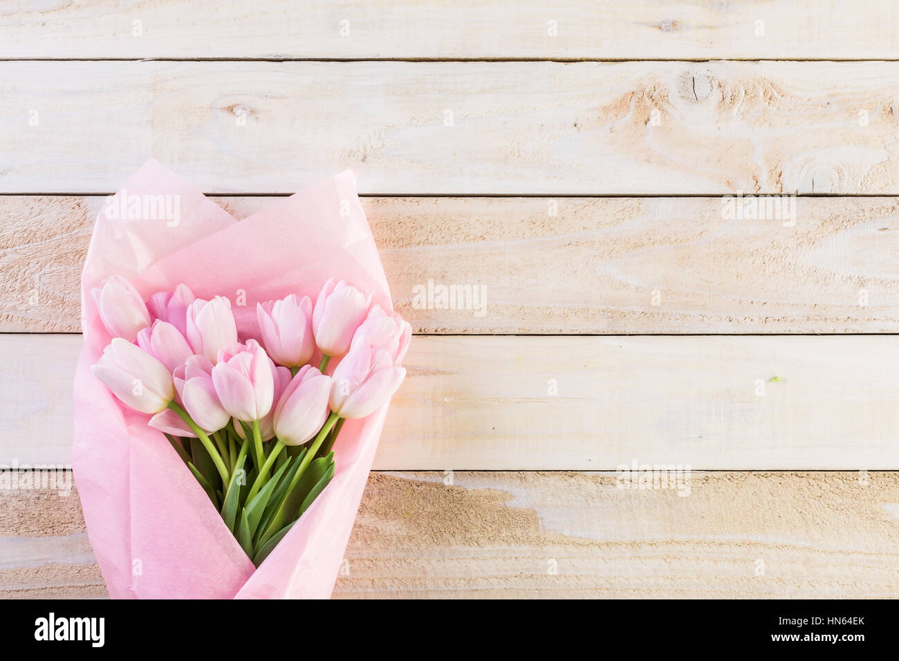 Bouquet of pink tulips wrappen in pink paper Stock Photo - Alamy