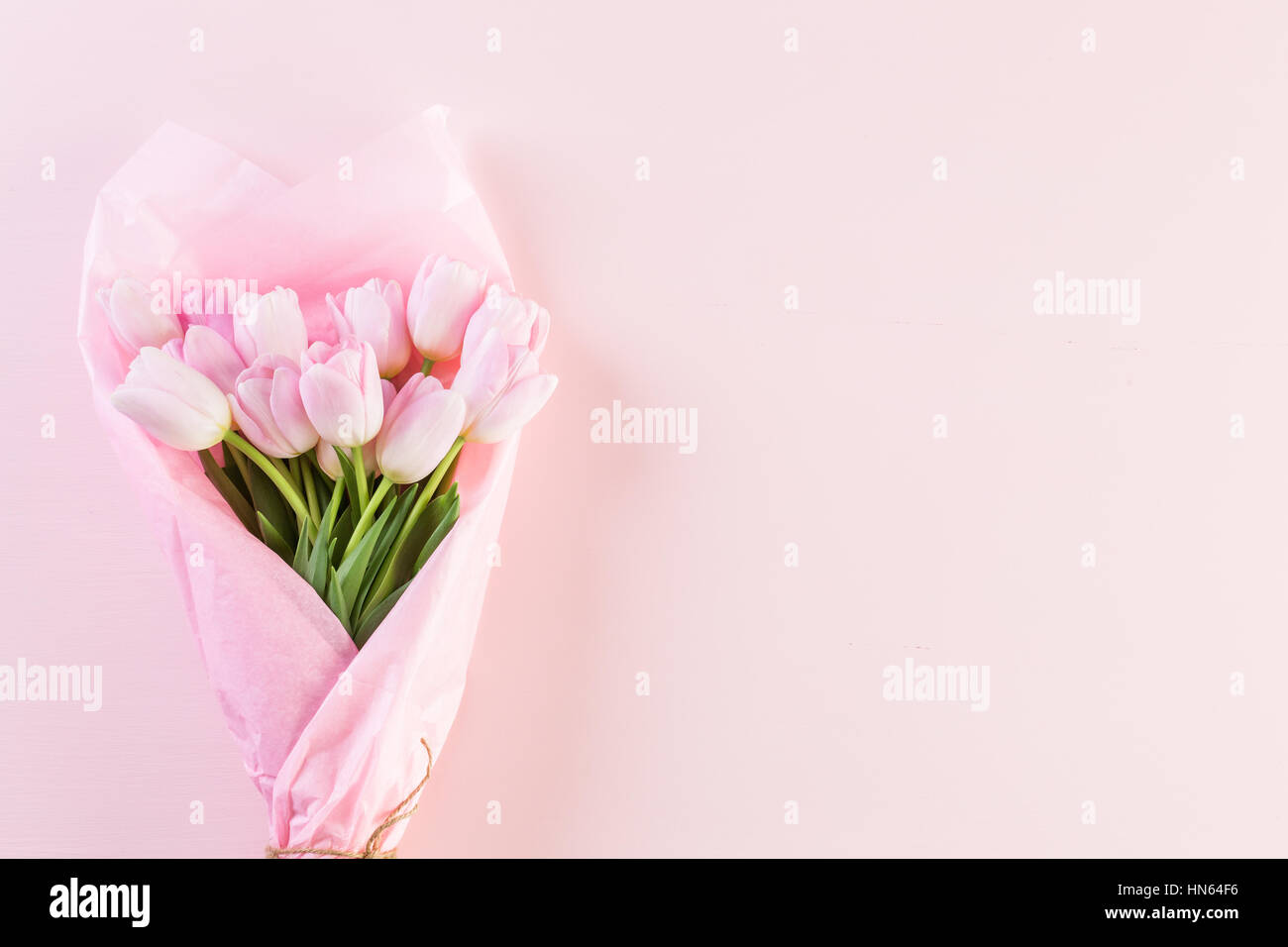 Bouquet of pink tulips wrappen in pink paper Stock Photo - Alamy