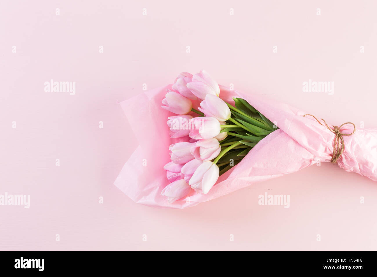 Bouquet of pink tulips wrappen in pink paper Stock Photo - Alamy