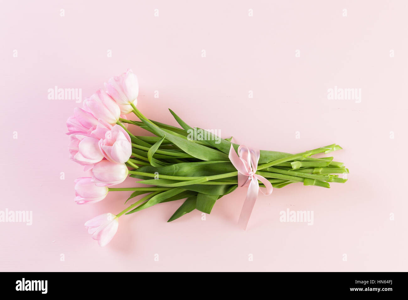 Bouquet of pink tulips wrappen in pink paper Stock Photo - Alamy
