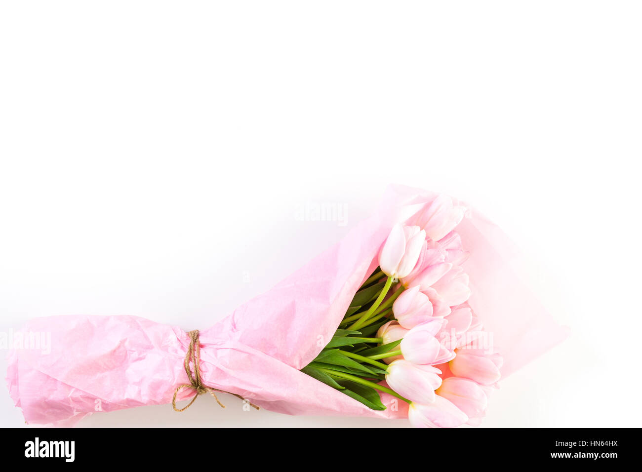 Bouquet of pink tulips wrappen in pink paper Stock Photo - Alamy