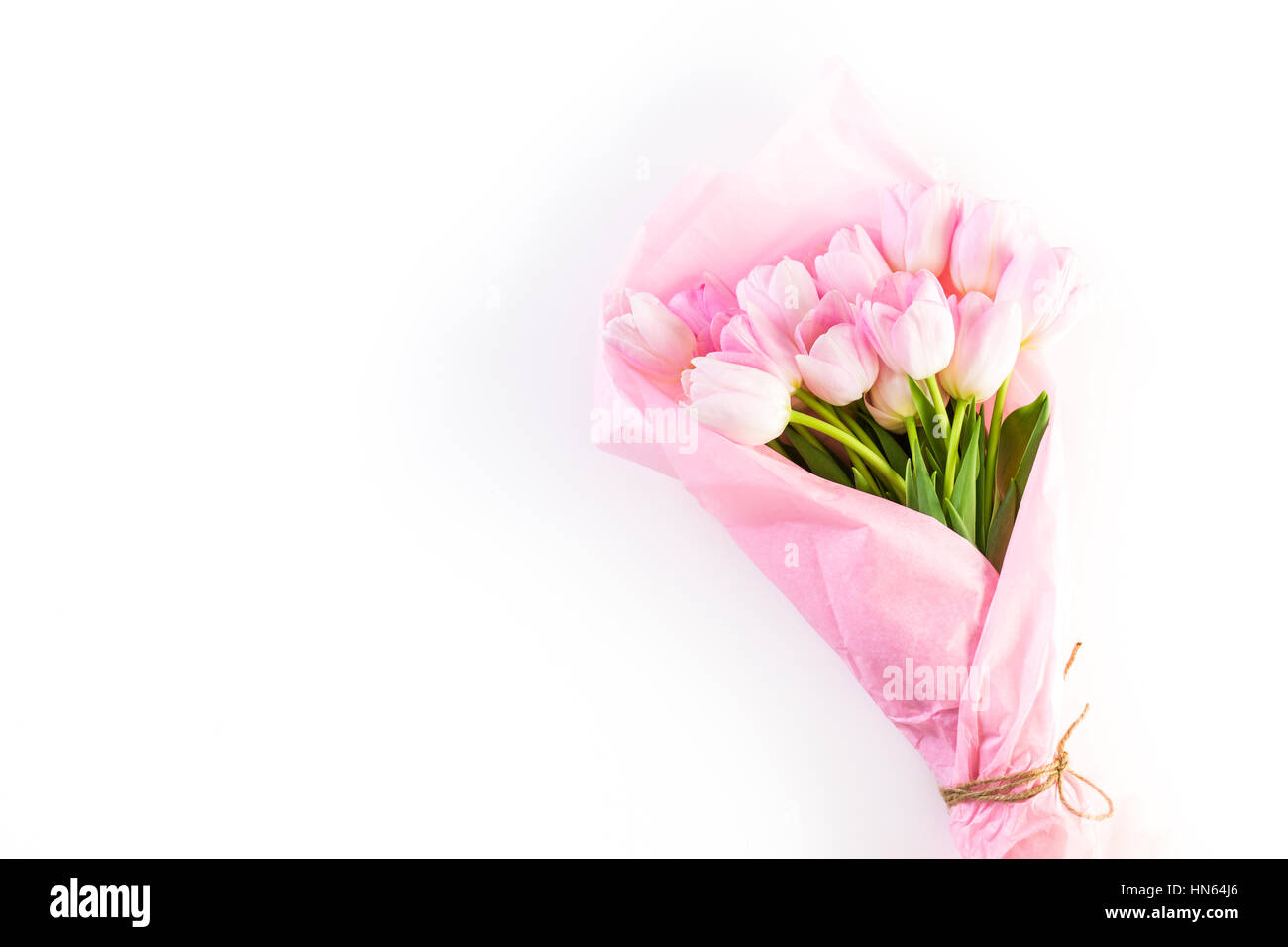 Bouquet of pink tulips wrappen in pink paper Stock Photo - Alamy