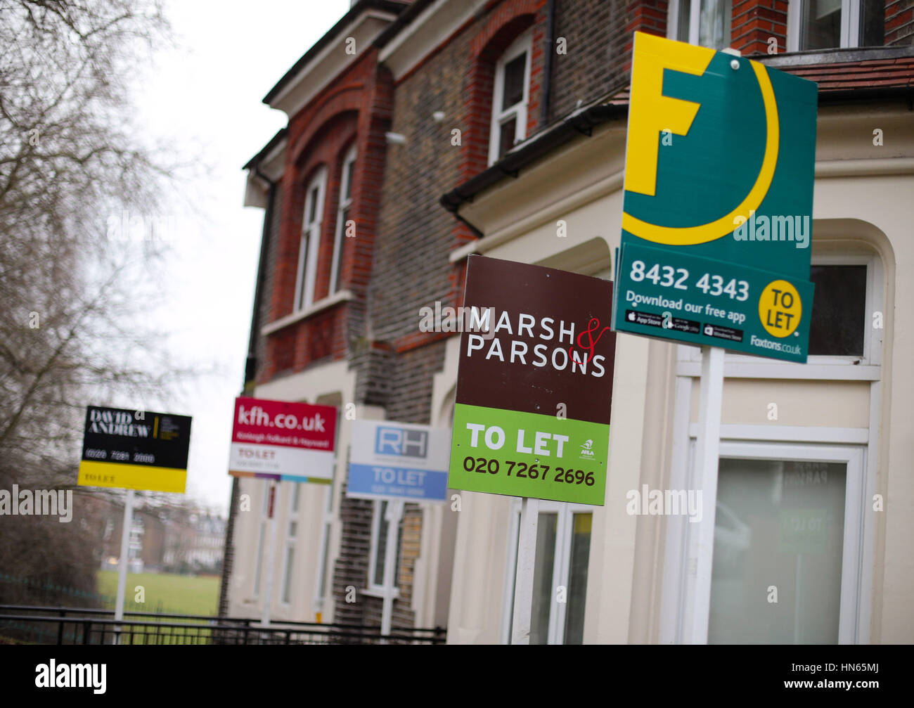 A row of To Let estate agent signs placed outside houses in north ...