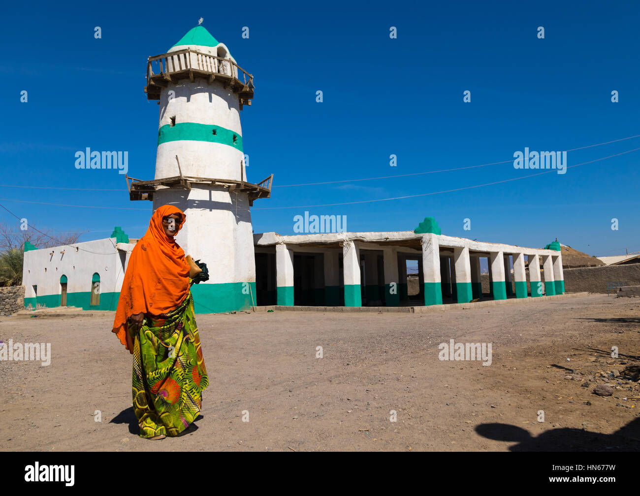 Afar woman in front of the sultan Alimirac Canfere mosque and its ...