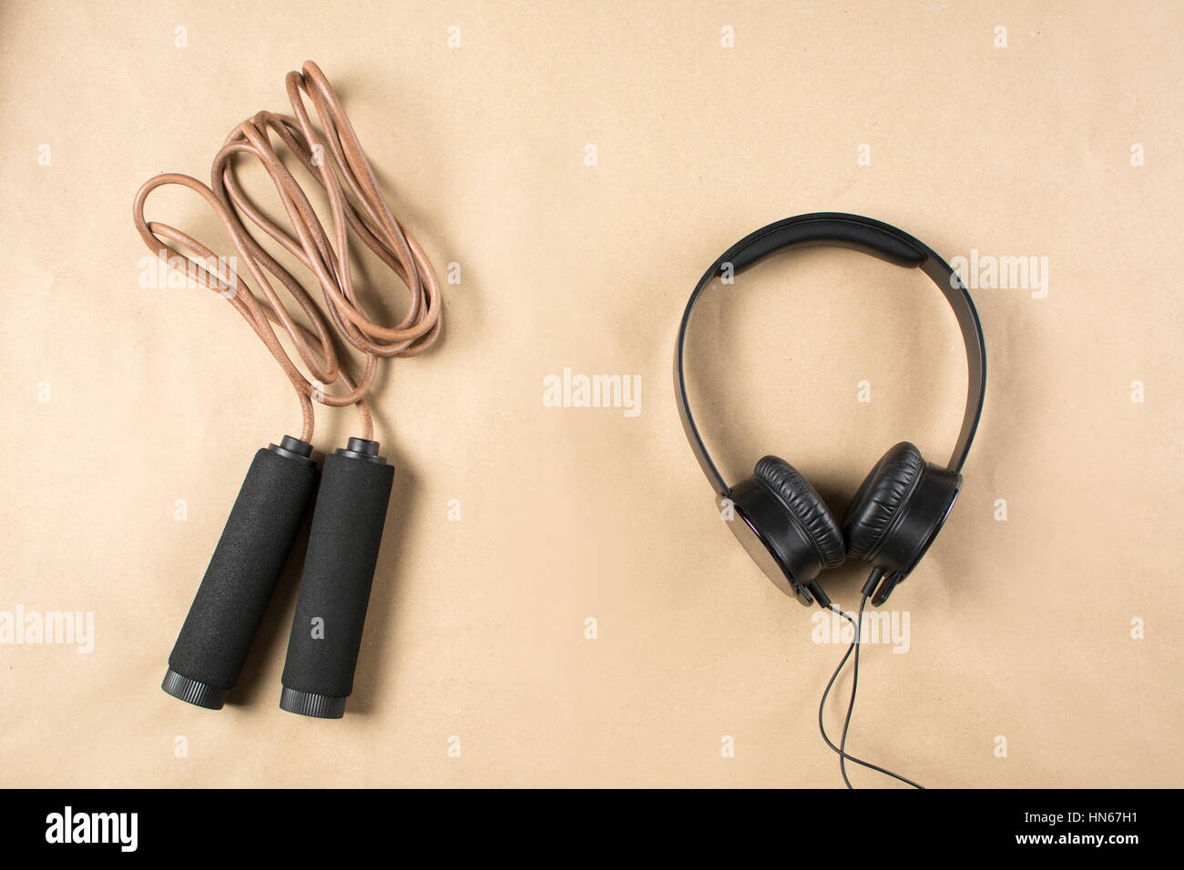 Leather jumping rope with headphonesl. Workout time Stock Photo - Alamy