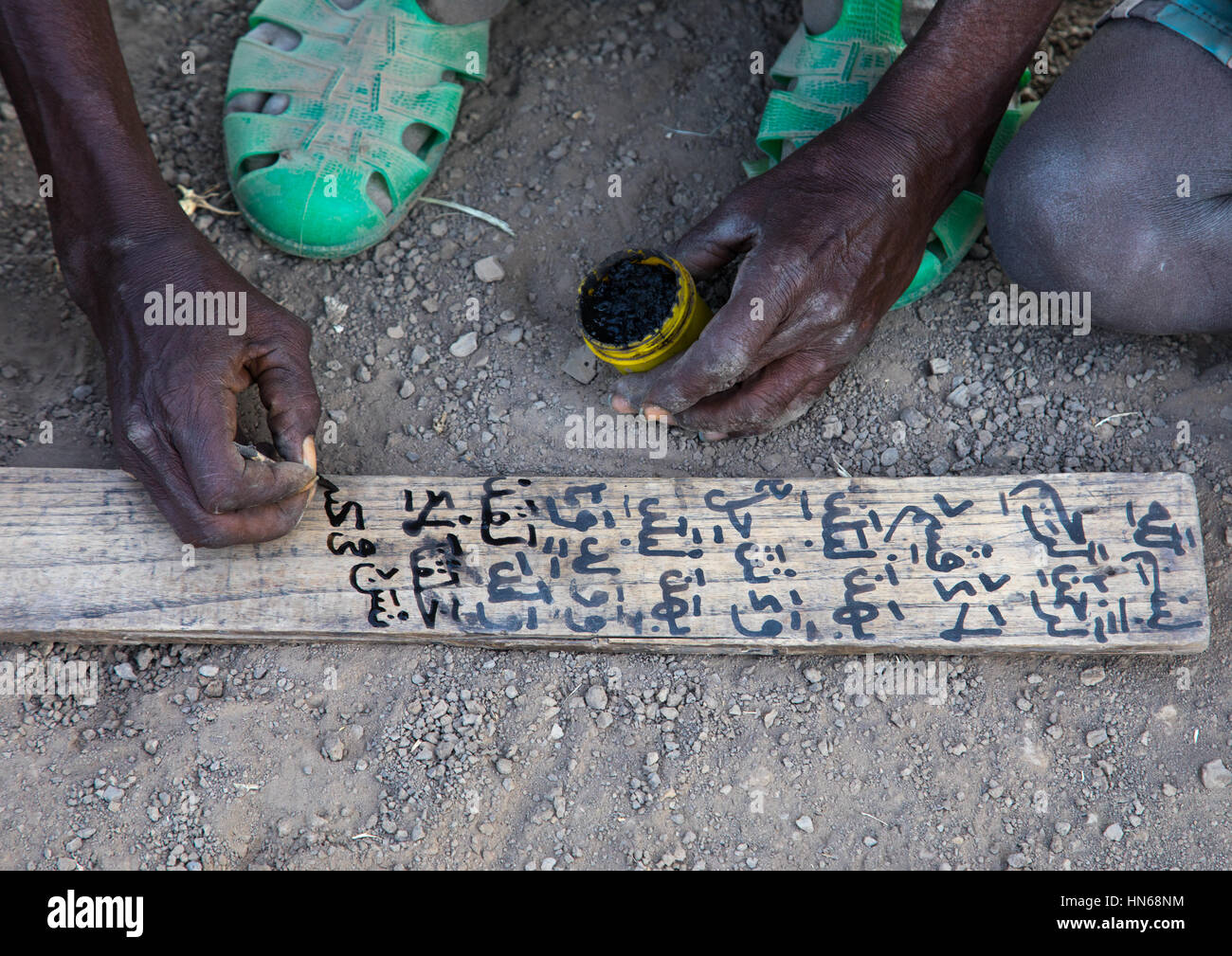 Afar tribe teacher writing on a wood board in a coranic school, Afar ...