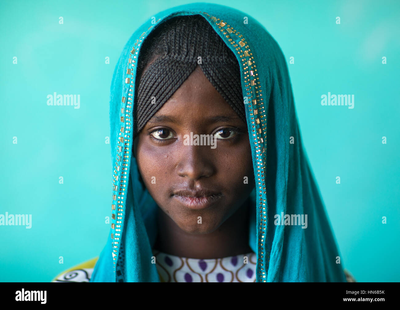 Portrait of an Afar tribe girl with braided hair and a blue veil, Afar ...