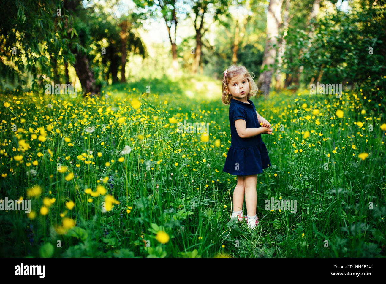 child playing outdoors in the grass Stock Photo - Alamy