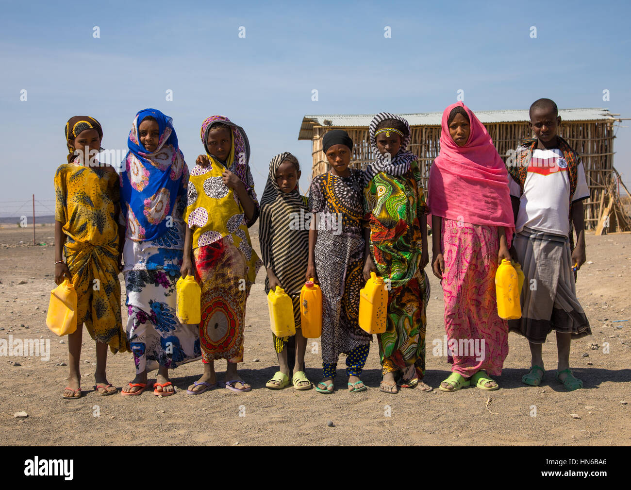 Children collecting water in jericans before going to school, Afar ...