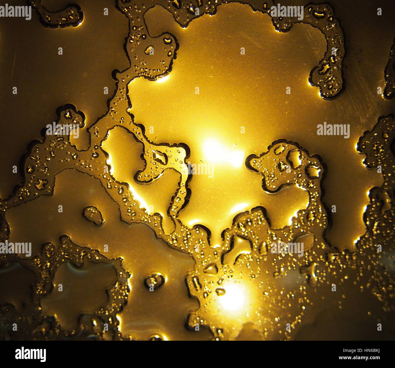 Low angle view of rain on the car roof against street light Stock Photo ...