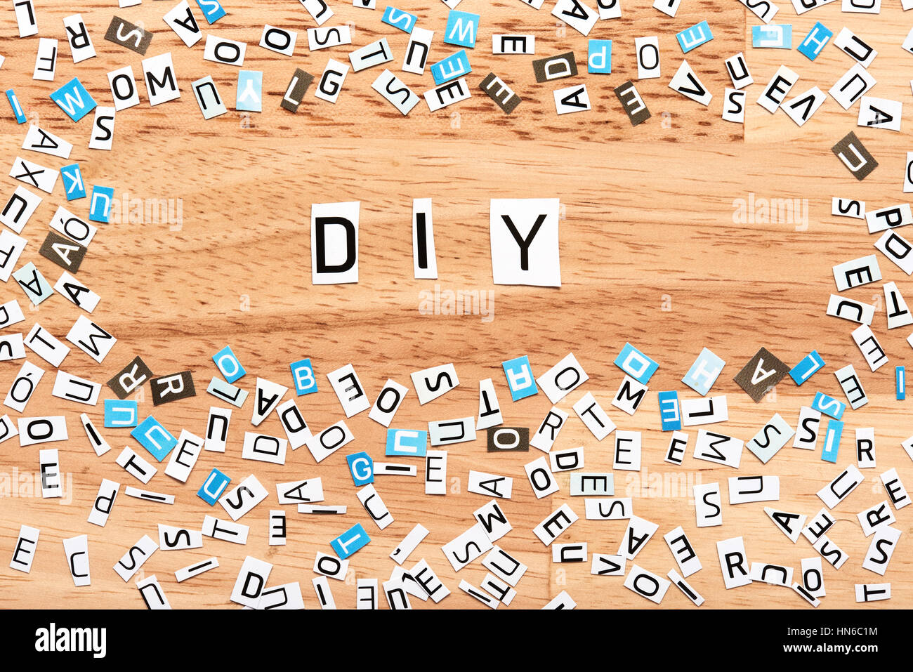 DIY word from cut out letters on wooden table Stock Photo - Alamy