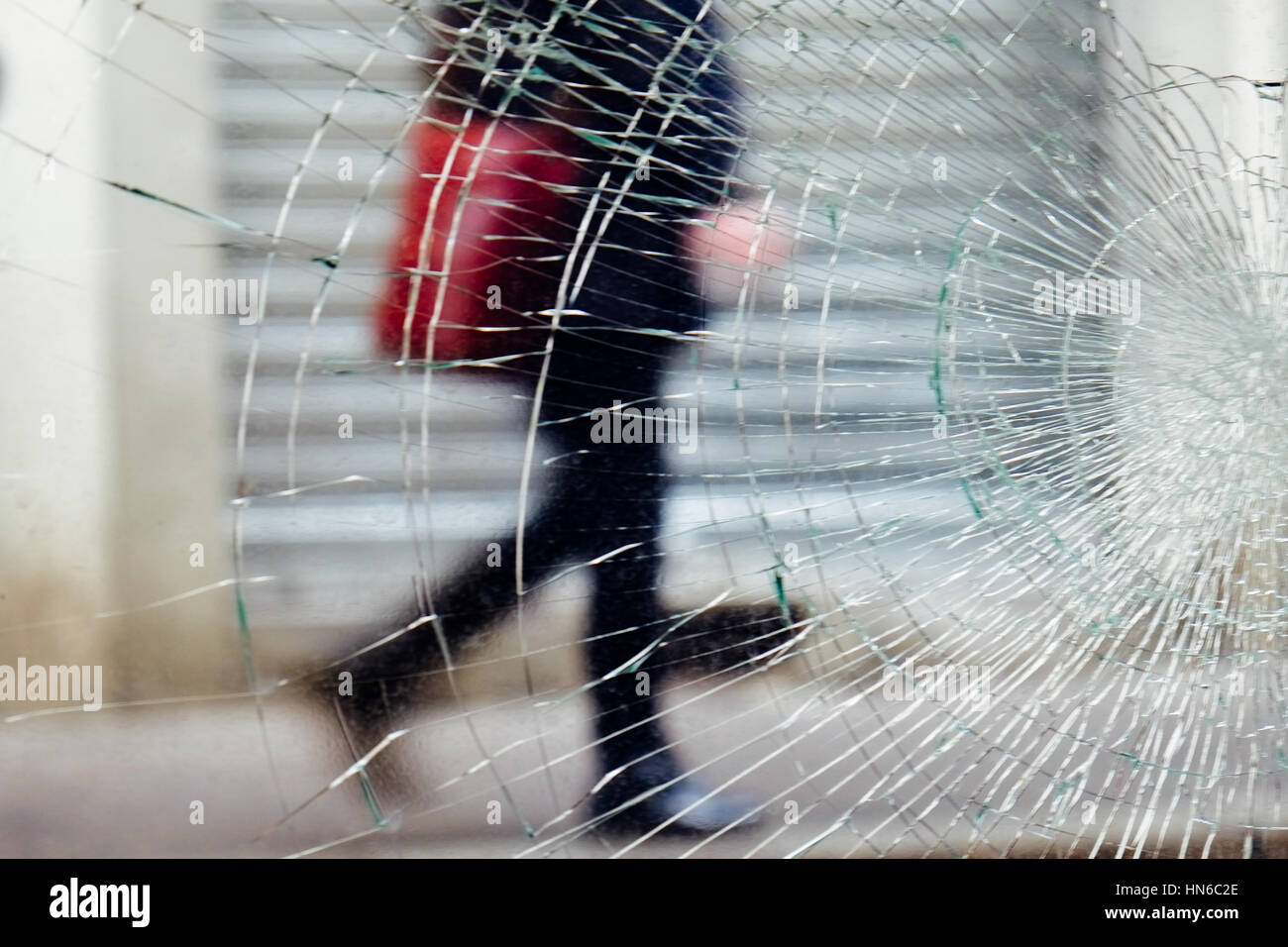 Moving subject pass between a broken glass and a city centre shop Stock ...
