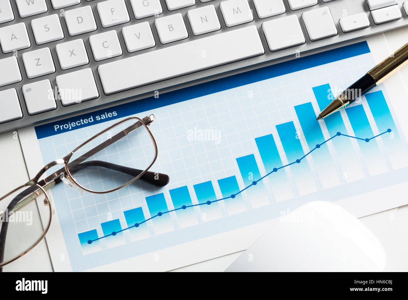Business workplace with keyboard mouse and papers with graphs and ...