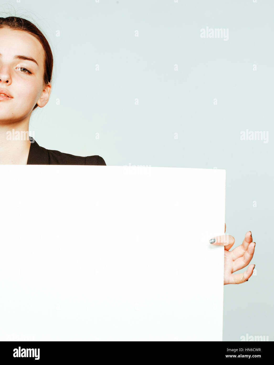 young pretty brunette girl with placard on white background Stock Photo ...