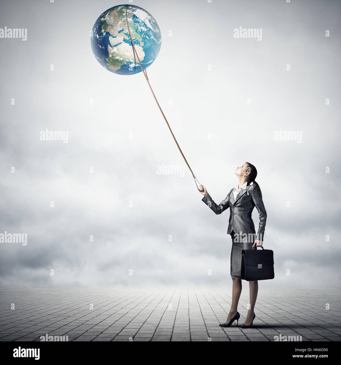 Businessman controlling Earth planet with lead. Elements of this image ...