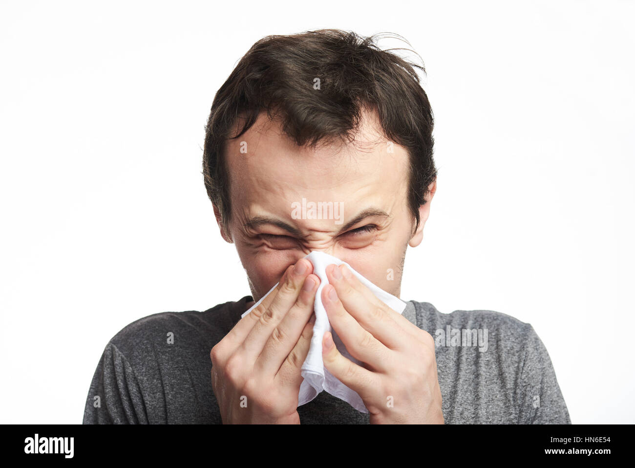 close up of man blowing nose isolated on white Stock Photo - Alamy
