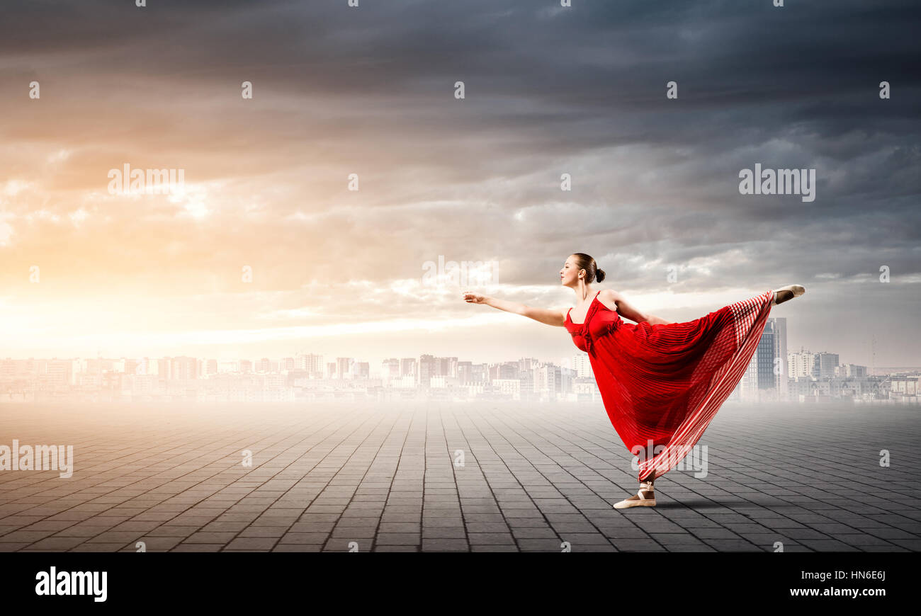 Passionate woman dancer in red dress reaching her hand Stock Photo - Alamy
