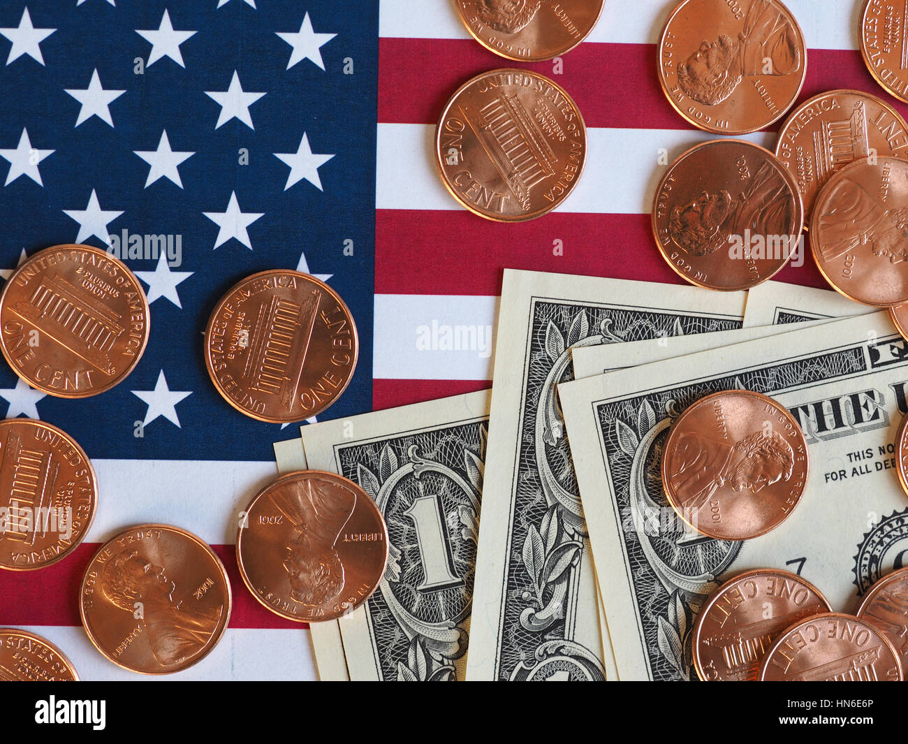 One Dollar banknotes and One Cent coins (USD) currency money over the ...