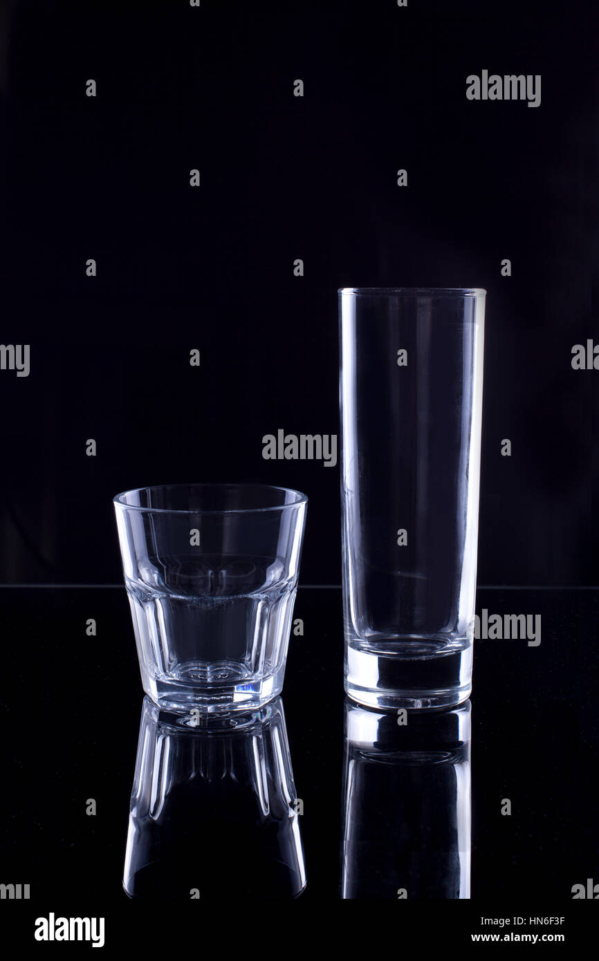 Empty glasses on a black background Stock Photo - Alamy