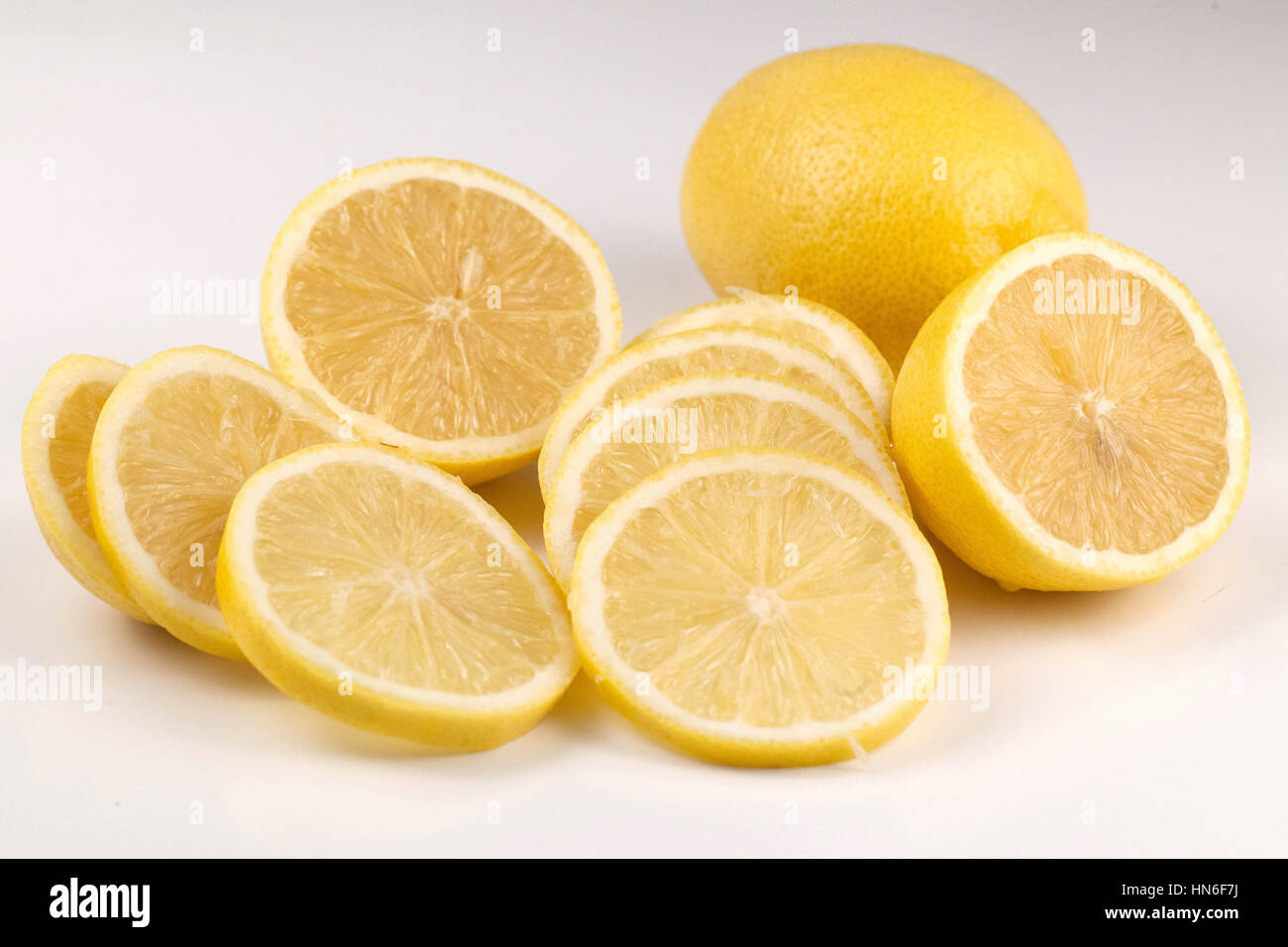Cut lemons. Sliced tropical fruit on a white surface Stock Photo - Alamy