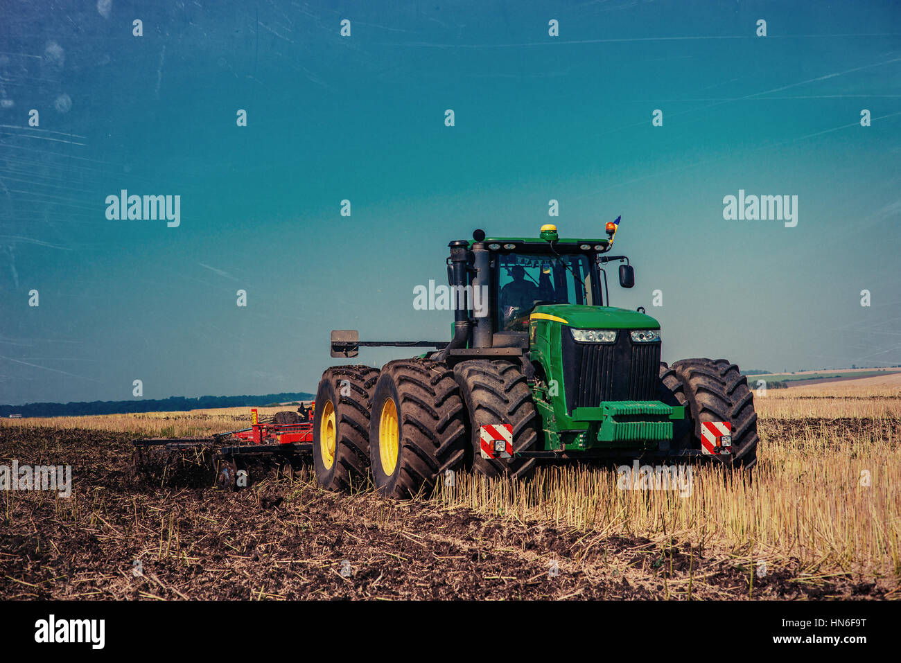 tractors working in the field Stock Photo - Alamy