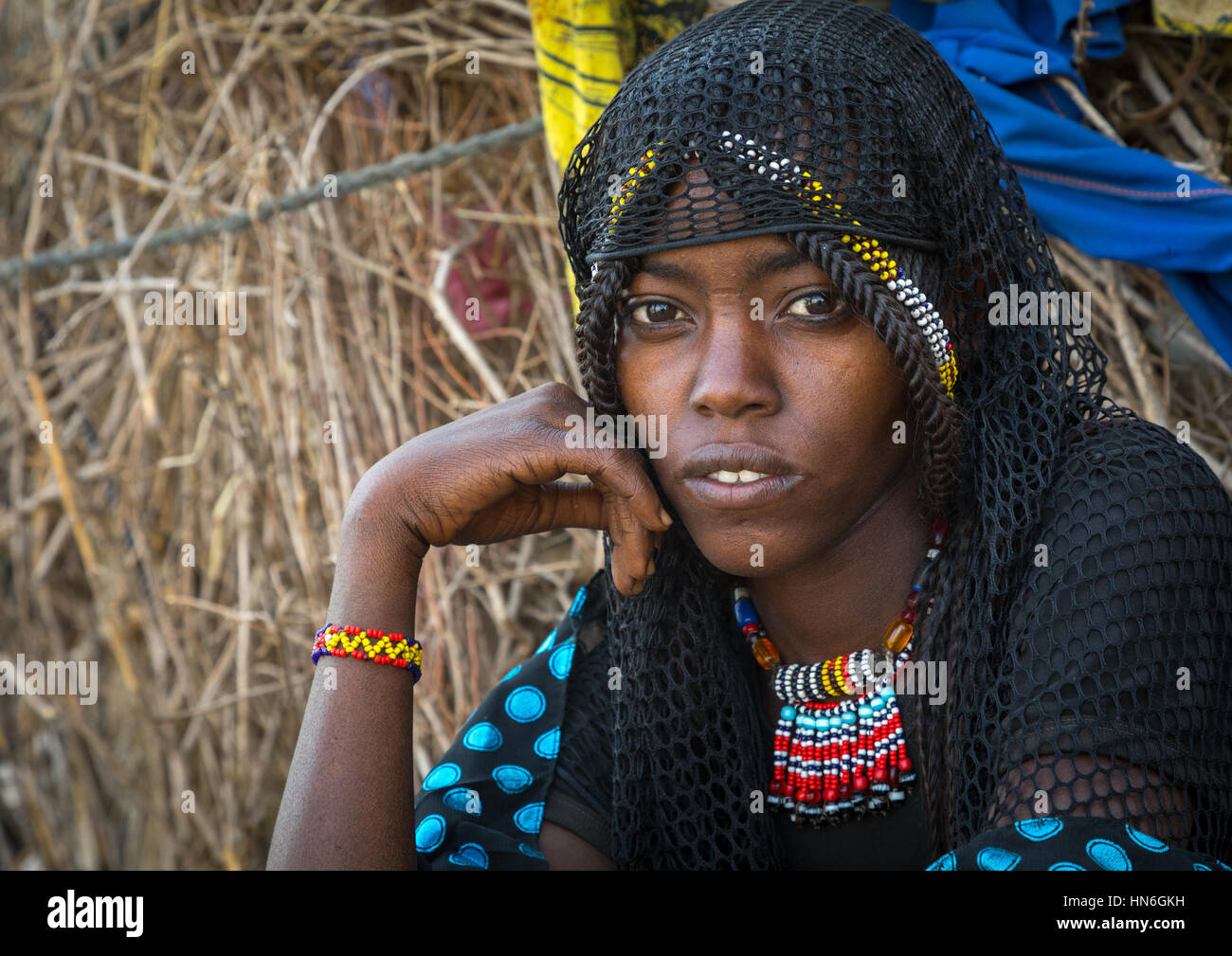Portrait of an Afar tribe woman with a black veil and a beaded necklace ...