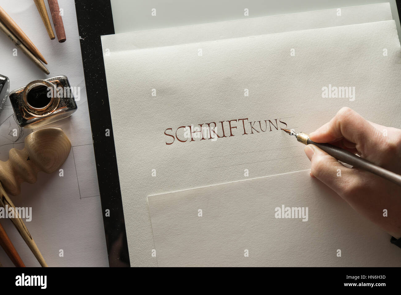 Calligraphy studio, hand writes text with ink, pen and nib, Roman ...