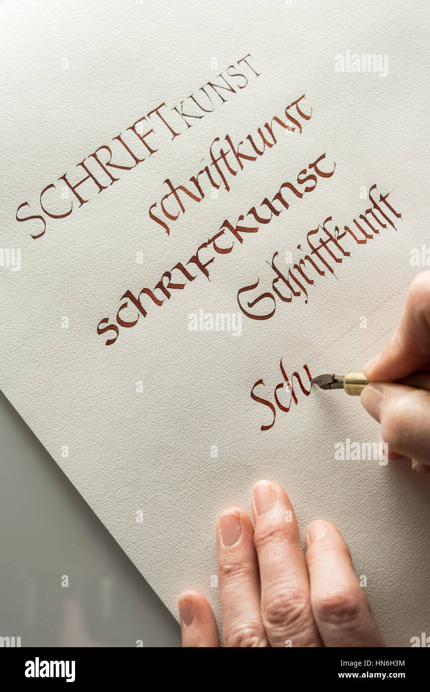 Calligraphy studio, hand writes text with ink, pen and nib ...