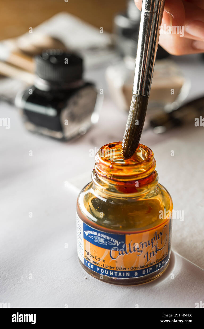 Calligraphy studio, hand wipes off brush, inkwell at back, Seebruck ...
