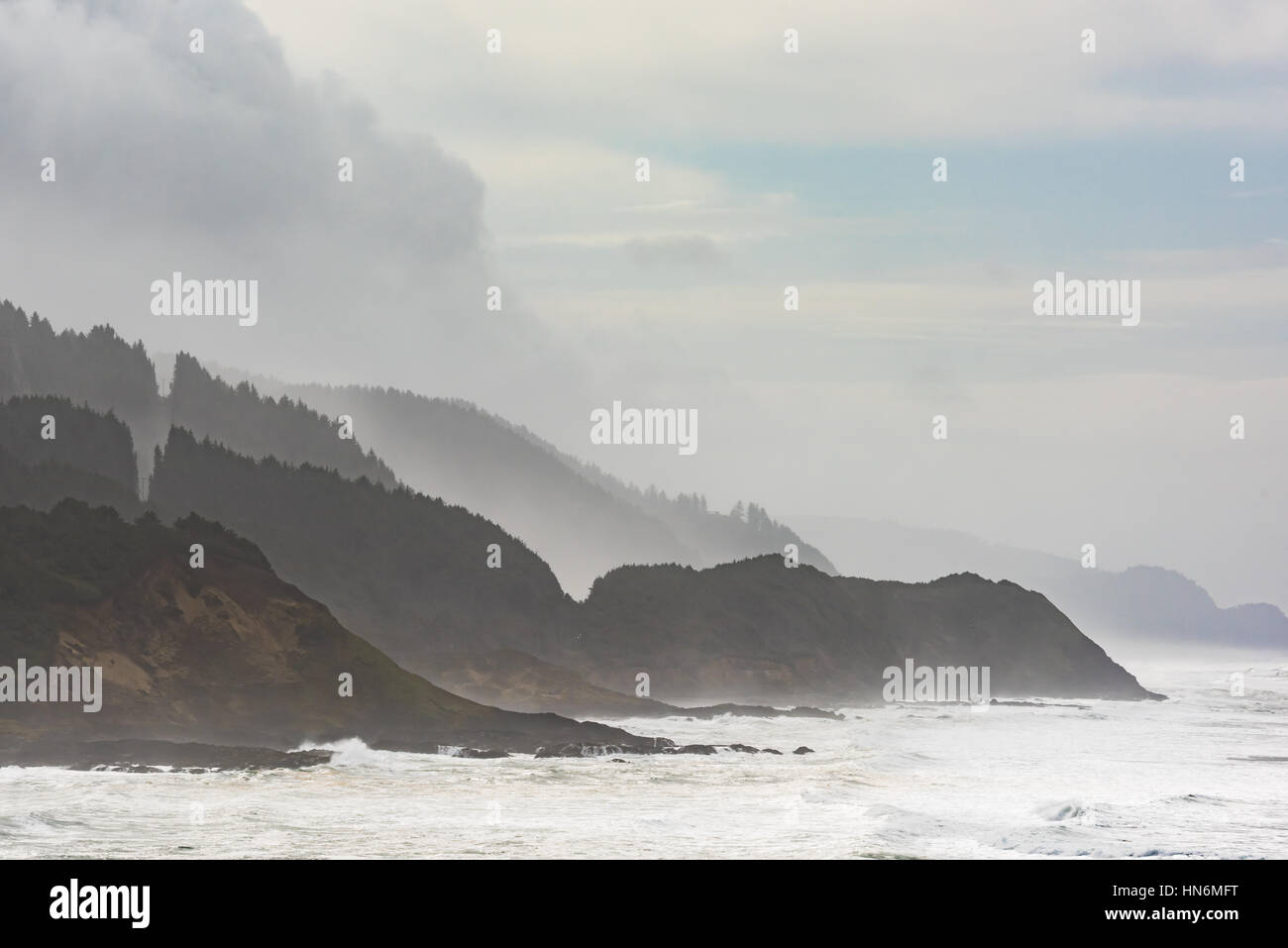 Misty and Foggy Oregon Coast cliffs and forests with stormy sky and ...