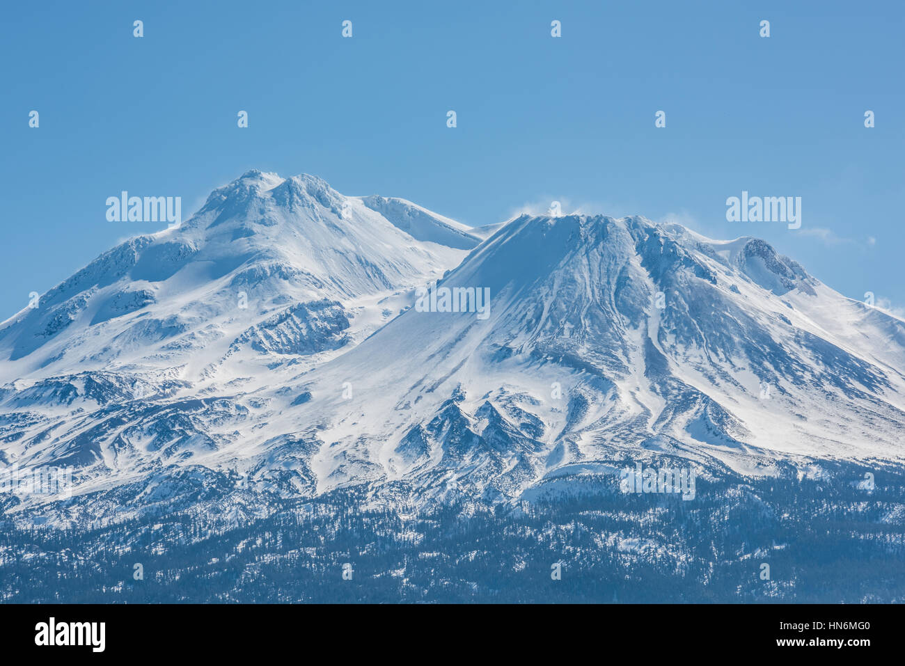 Snowcapped Mount Shasta volcano during winter with valley view and ...