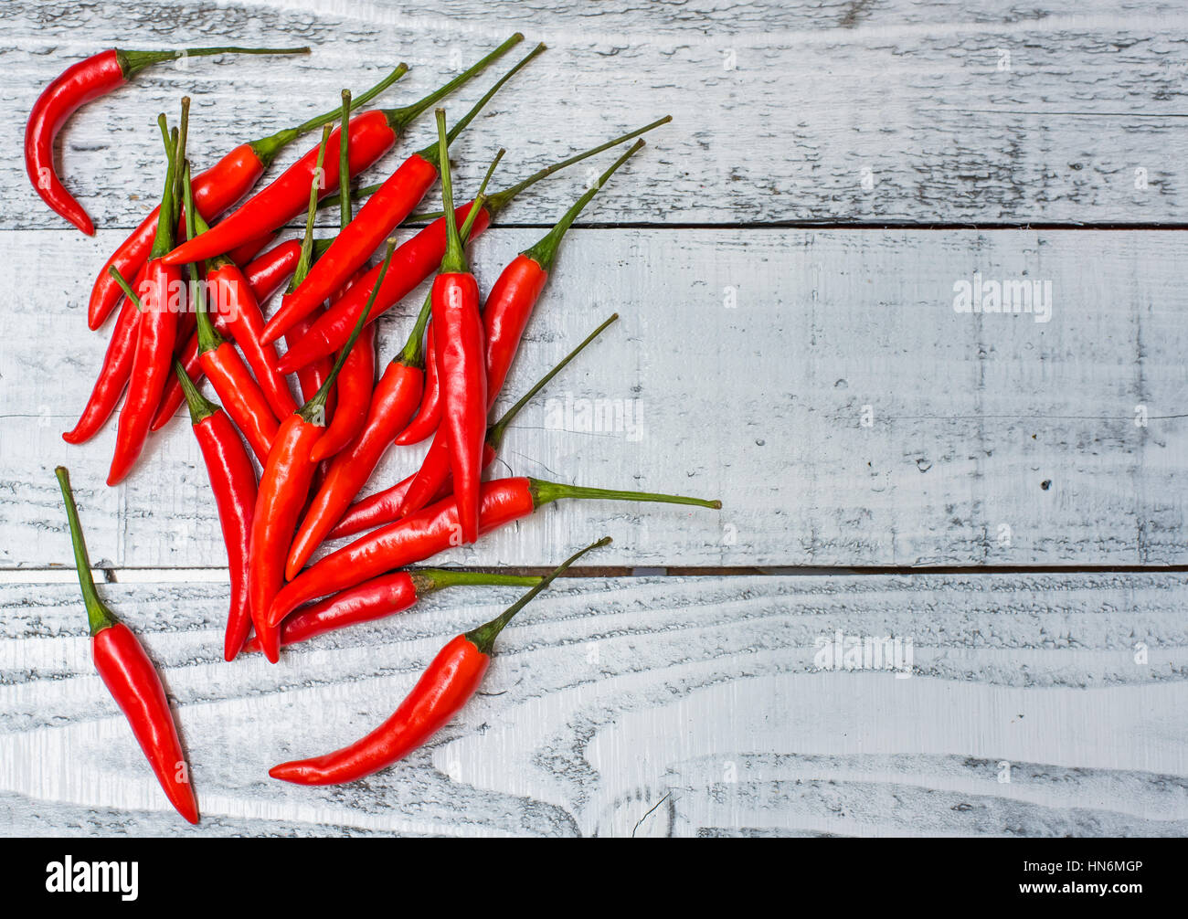 Hot and spicy red chilli on wood table background Stock Photo - Alamy
