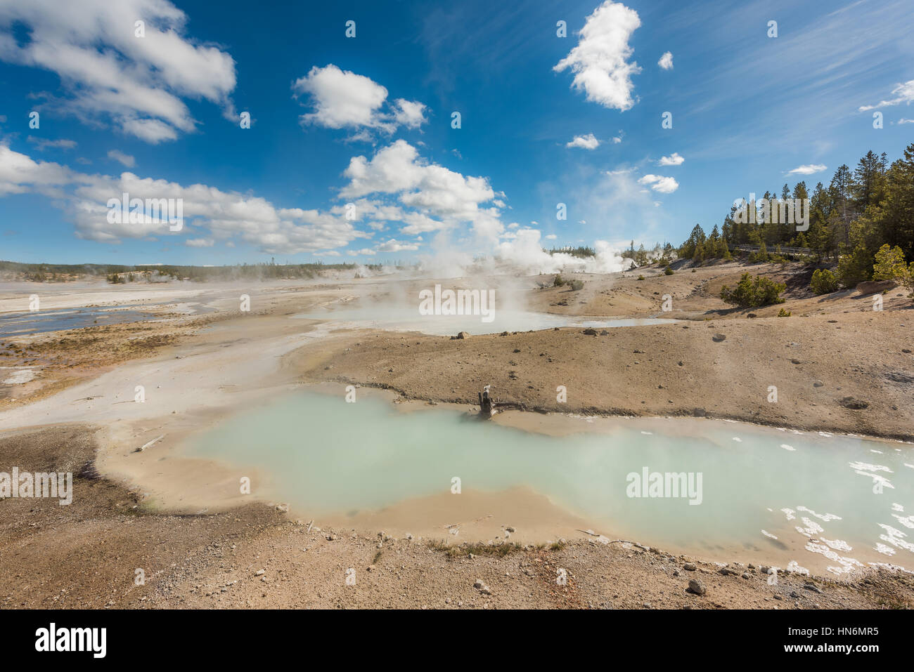 Hot spring pools with blue colors and steam geysers in Yellowstone ...