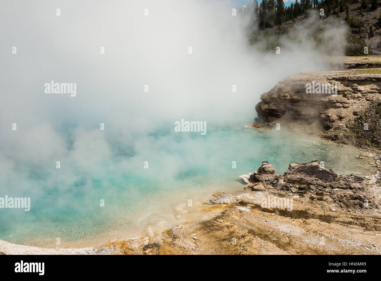 Light blue pool Excelsior geyser with steam rising from hot spring in ...