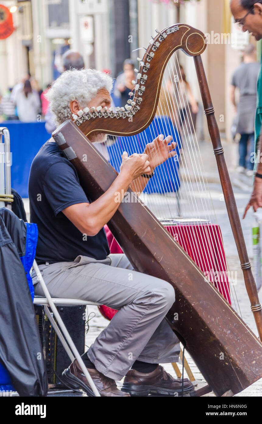 Quebec City, Canada - July 27, 2014: Older man playing a harp on ...