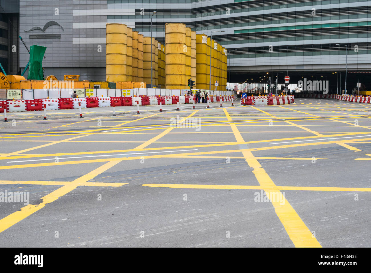 Crisscrossing yellow traffic lines at an intersection Stock Photo - Alamy