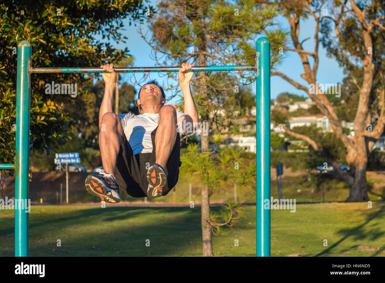 Fit muscular man doing pull ups in outdoor park Stock Photo - Alamy