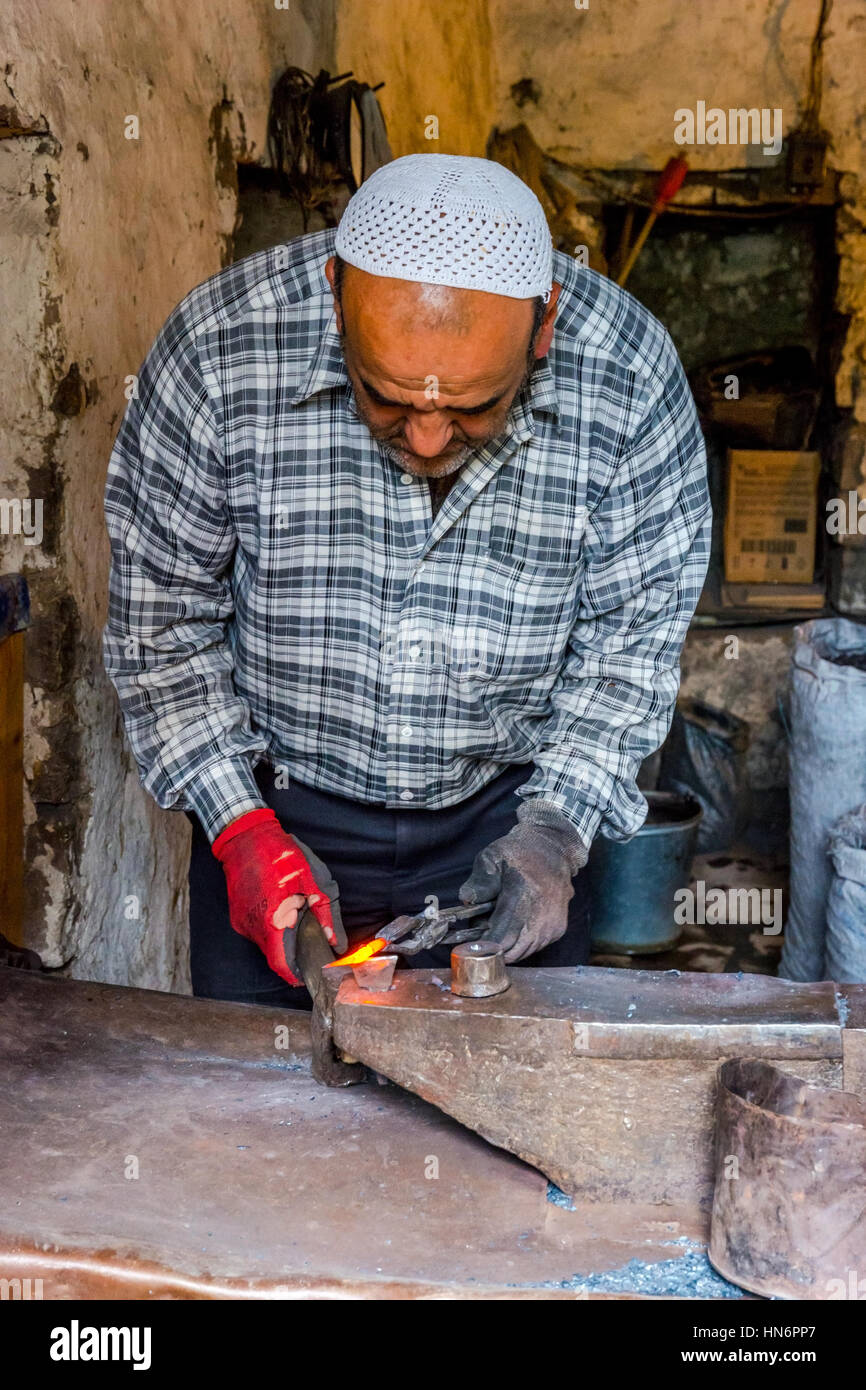 LAHICH, AZERBAIJAN - OCTOBER 1: Senior blacksmith making nails with ...