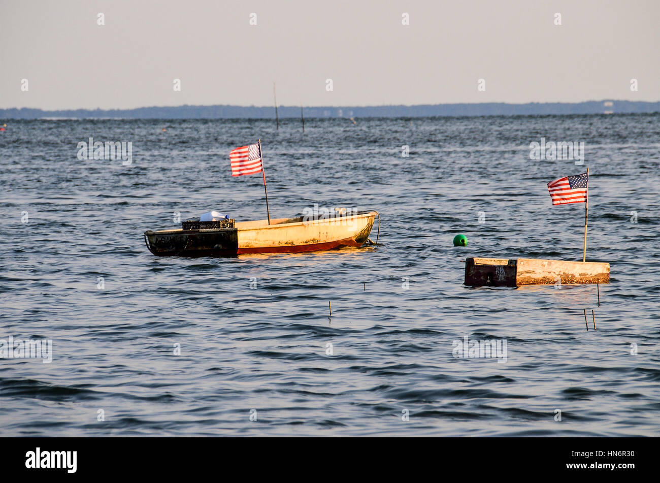 Two small boats in ocean with American flags Stock Photo - Alamy