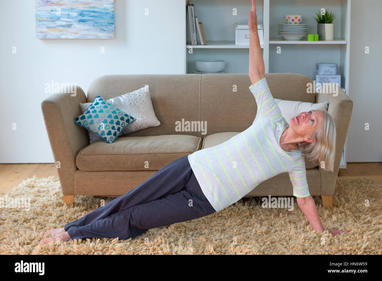 Senior lady doing yoga stretching hi-res stock photography and images ...