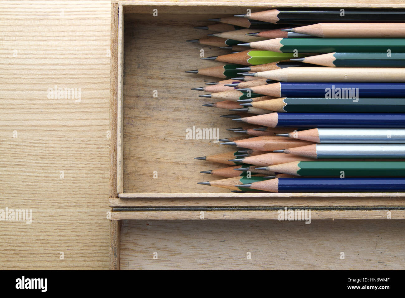 Box of pencils open on wooden table, top view Stock Photo - Alamy
