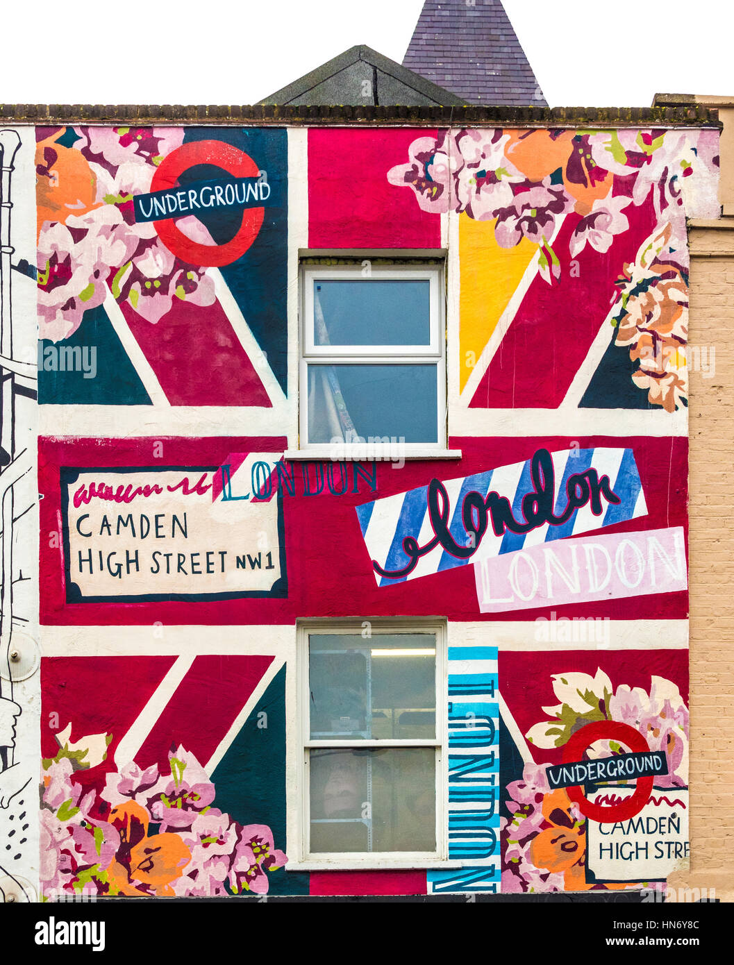 Colourful painted advertising slogans on outside of shop in Camden High ...