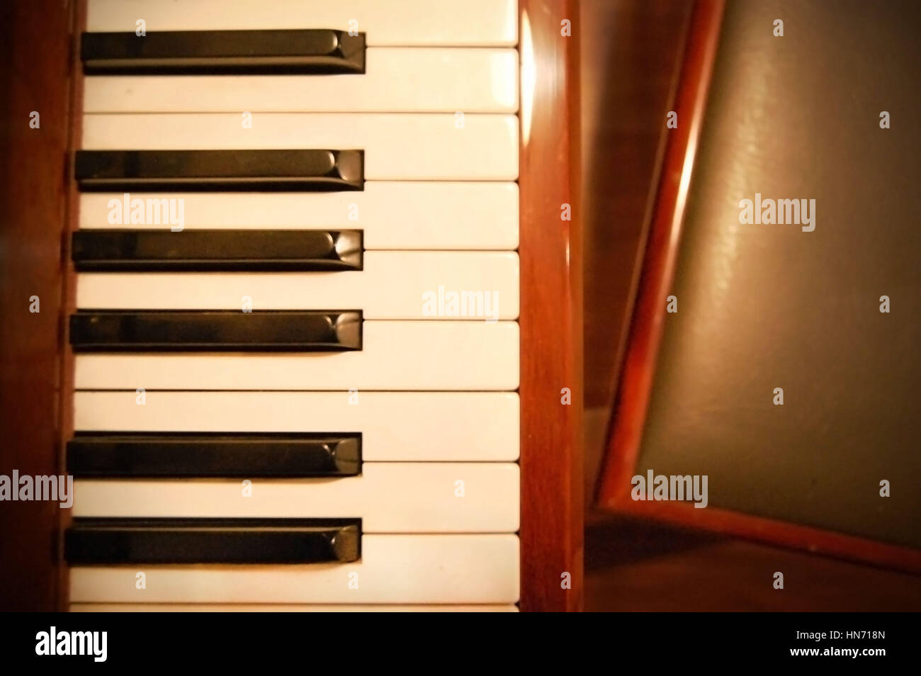 Aerial shot of piano keys and a corner ot the bench tucked under the ...