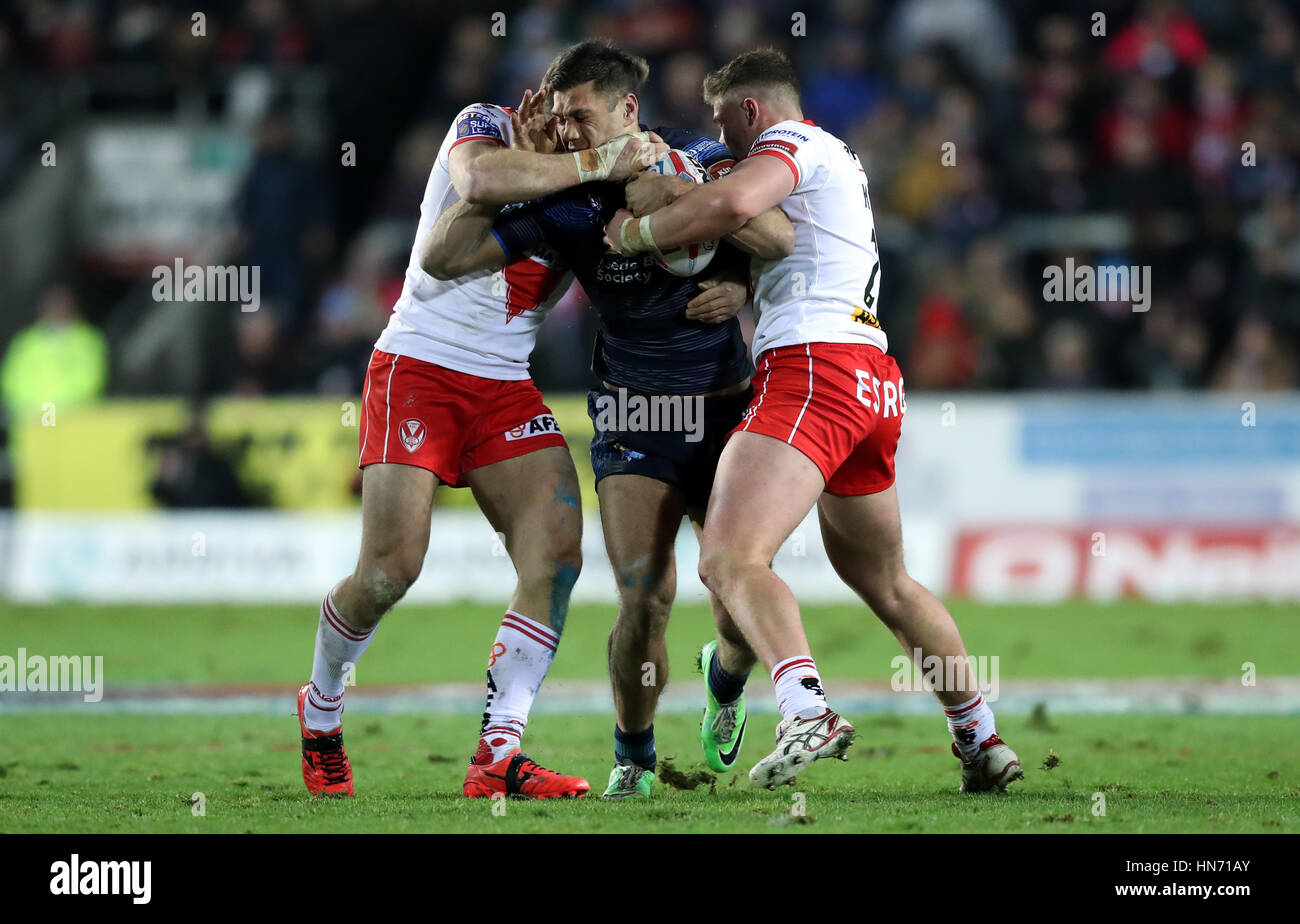 St Helens' James Roby (left) and Morgan Knowles tackle Leeds' Joel Moon ...