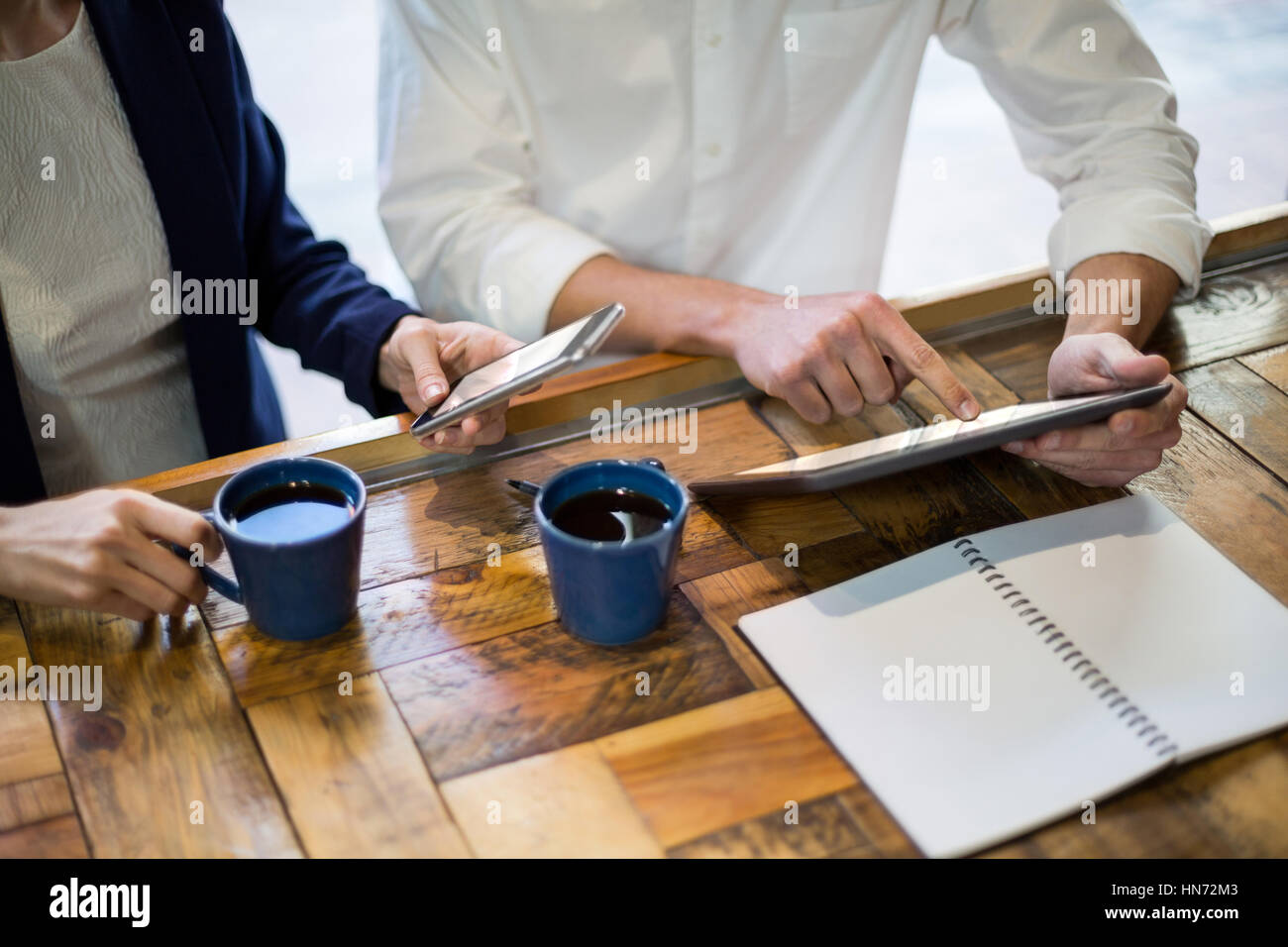 Female executive using mobile counter hi-res stock photography and ...