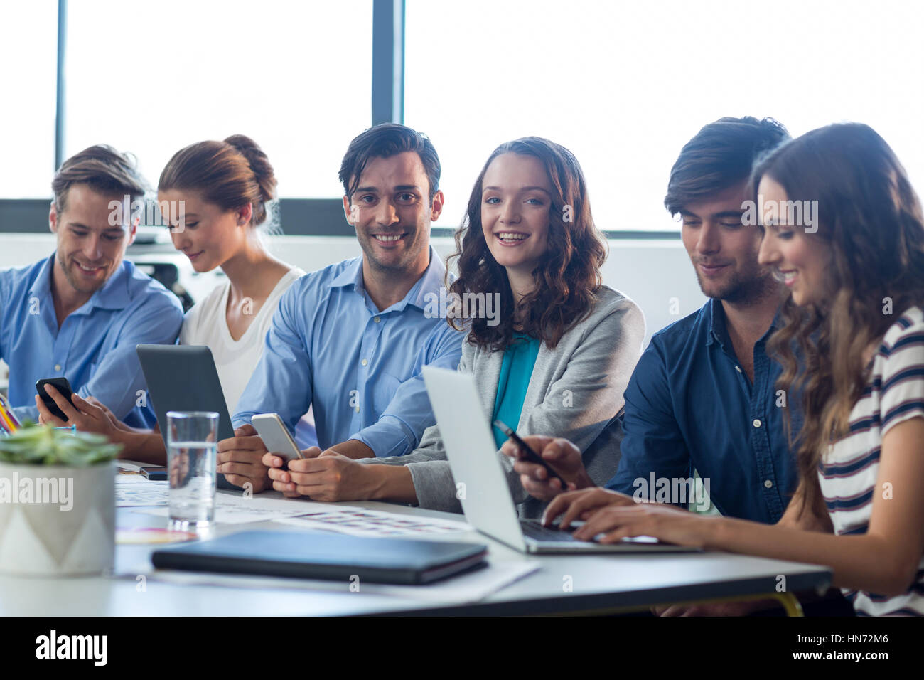 Team of graphic designers working together in office Stock Photo - Alamy