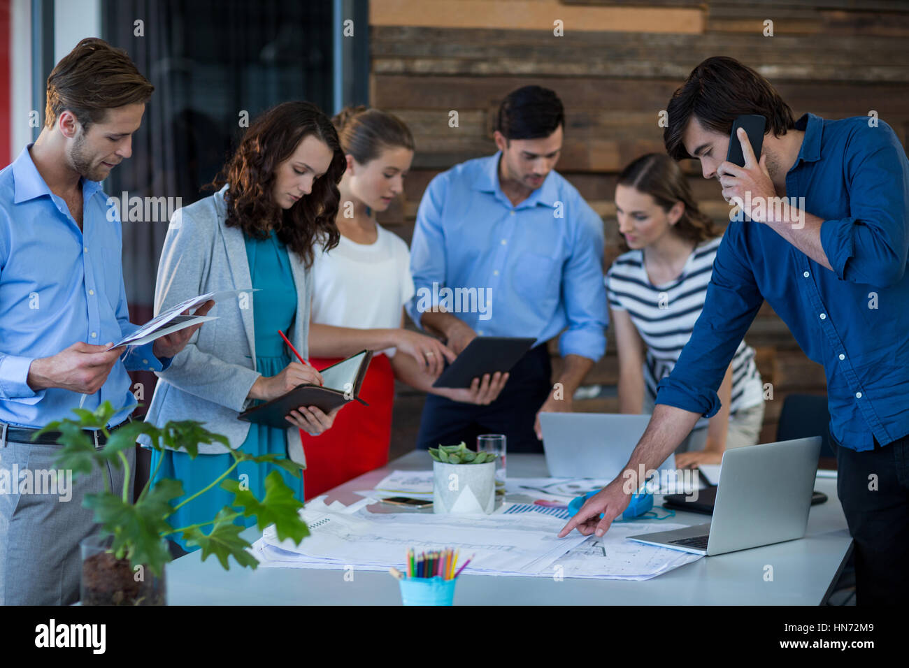 Team of graphic designers working together in office Stock Photo - Alamy