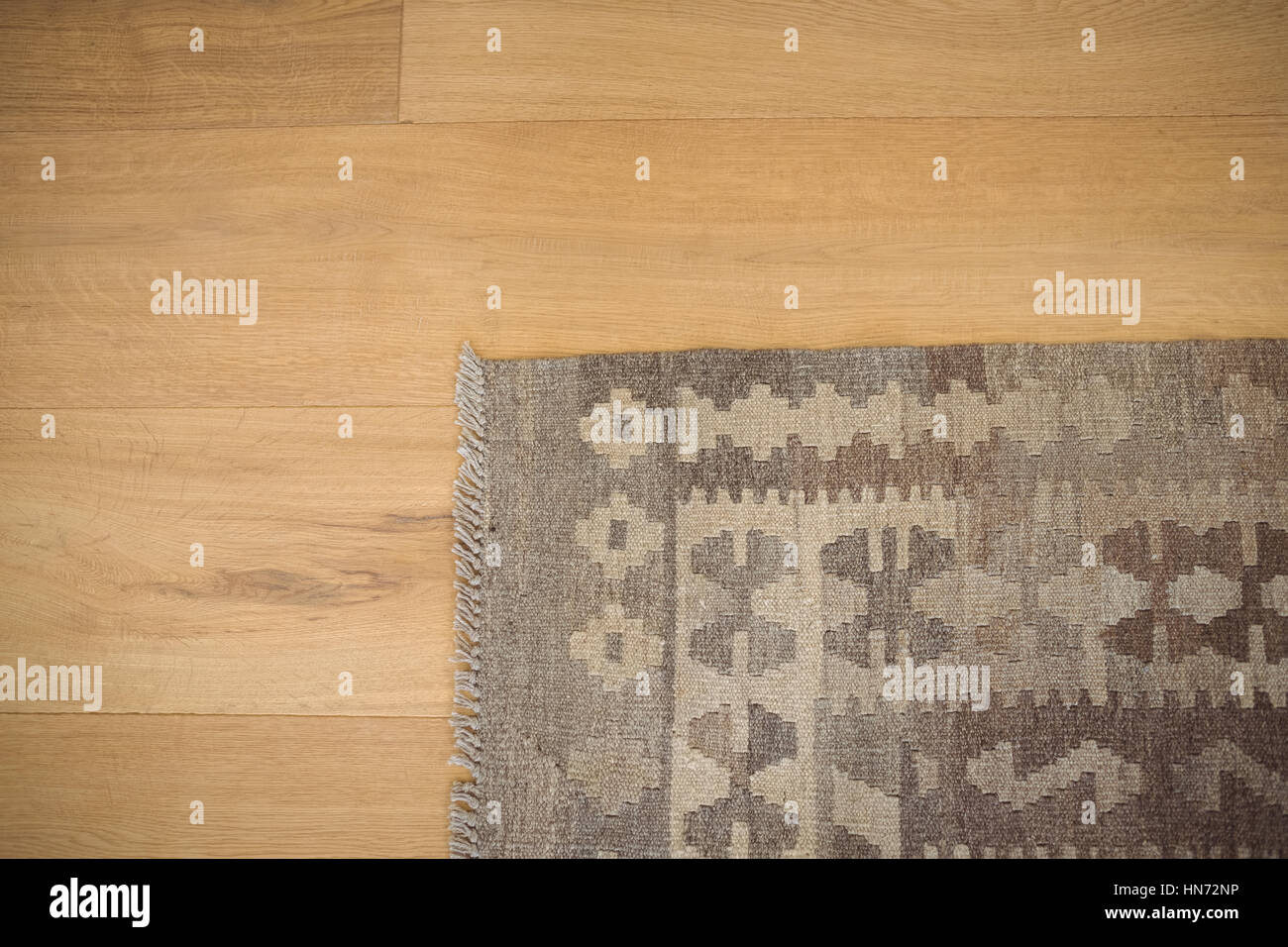 Overhead view of floor mat on wooden floor at home Stock Photo - Alamy