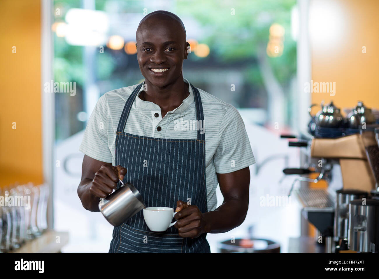 Portrait of waiter making cup of coffee at counter in cafe Stock Photo ...
