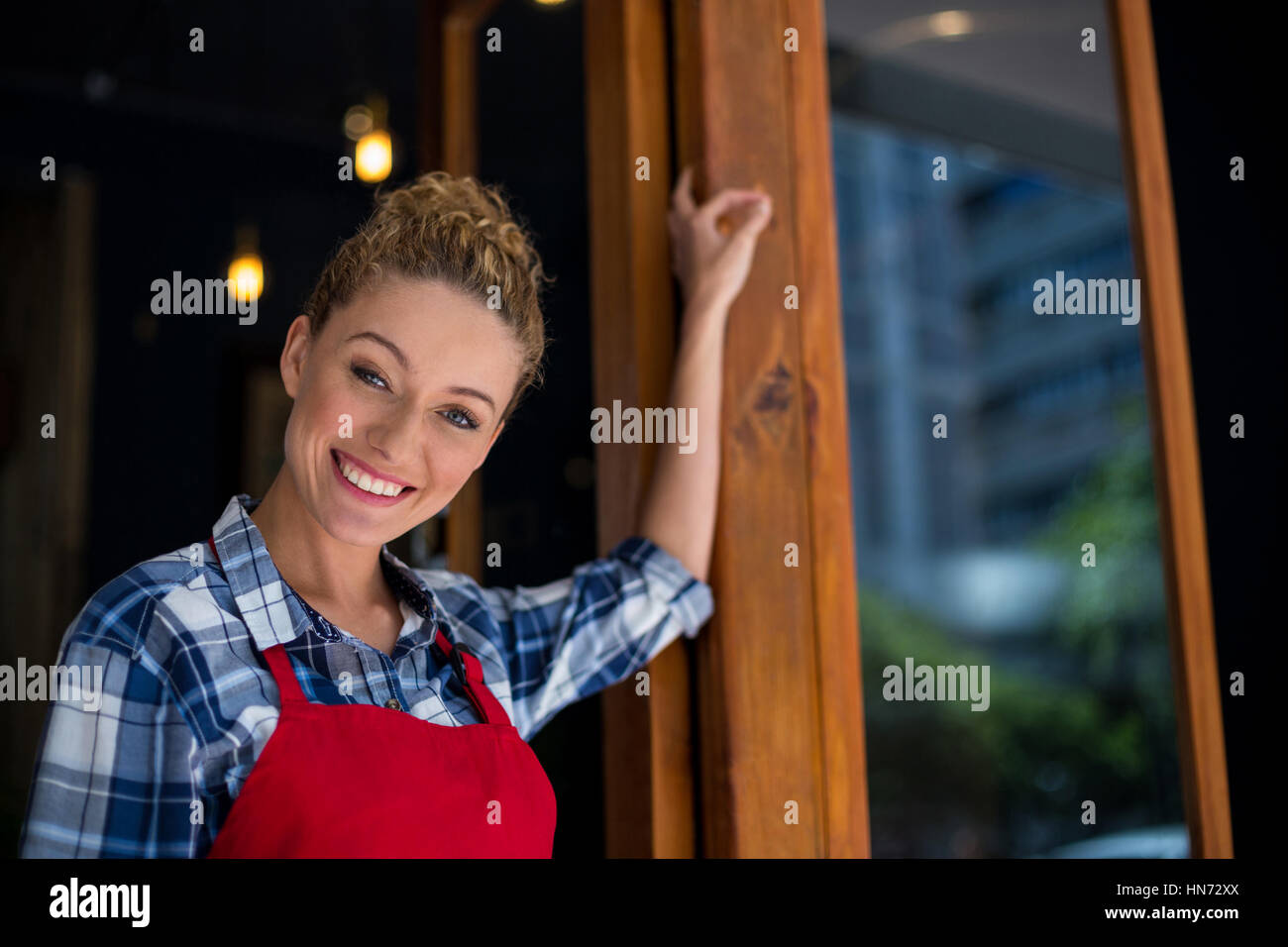Portrait of smiling waitress standing at window in cafÃƒÂ© Stock Photo ...